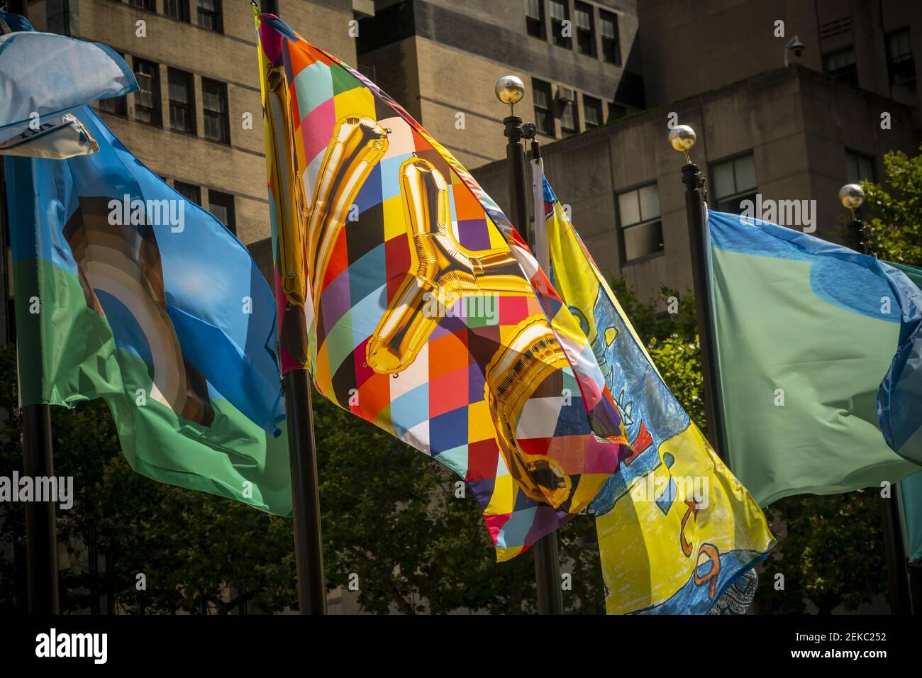 The flag designed by Jeff Koons, center, joins the 193 flags ...