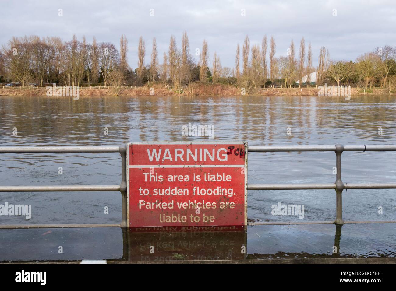 A parked vehicles sudden flooding warning sign at Mortlake, London, U.K ...