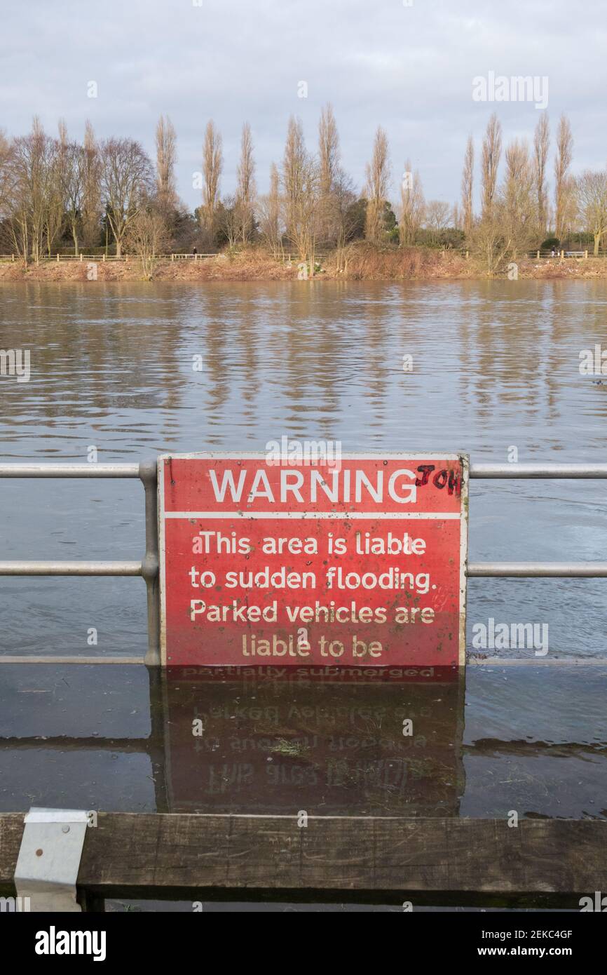 A parked vehicles sudden flooding warning sign at Mortlake, London, U.K ...