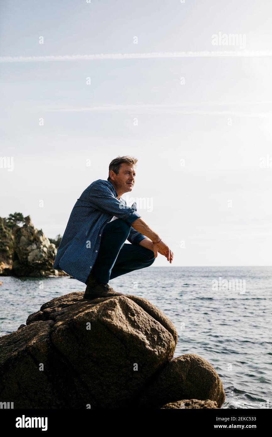 Crouching pensive hi-res stock photography and images - Alamy