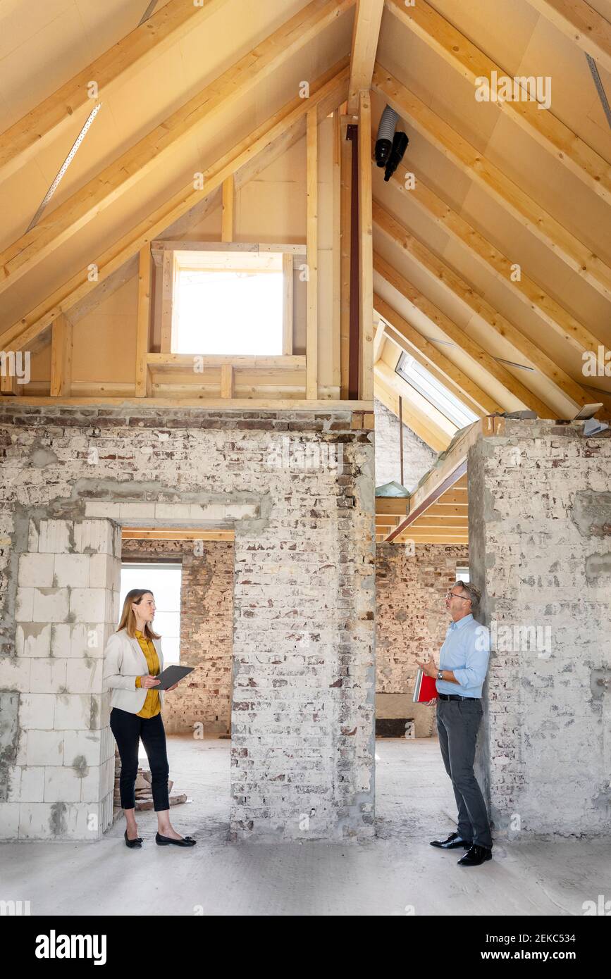 Expertise team having discussion while standing with social distance at ...