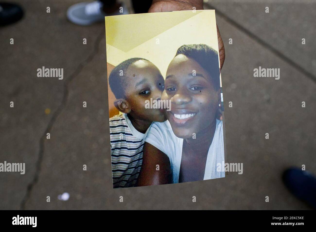 Jalisa Ford holds a photo of herself with her 9-year-old son Janari ...