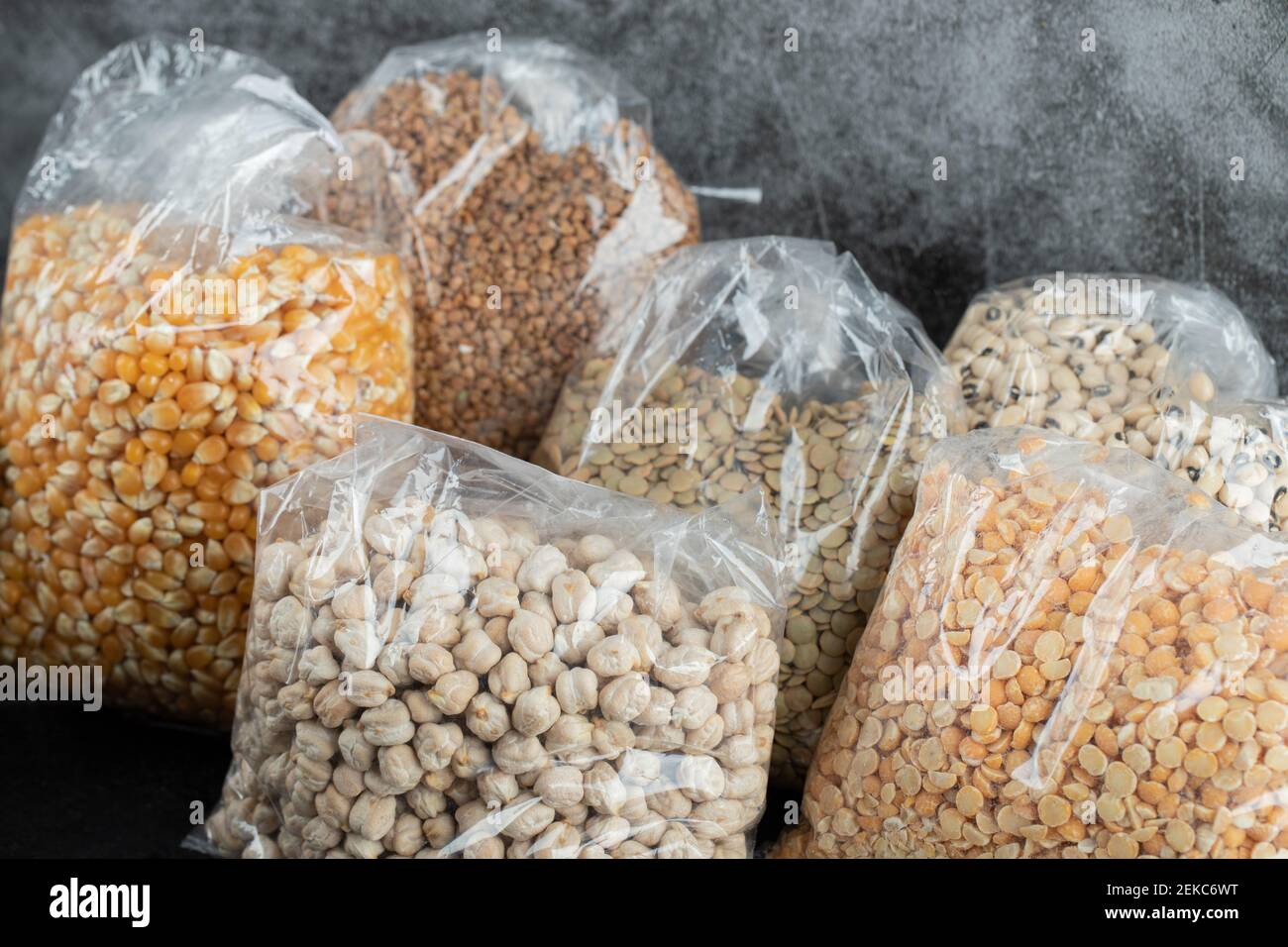 Different kinds of beans packed on a gray background Stock Photo - Alamy