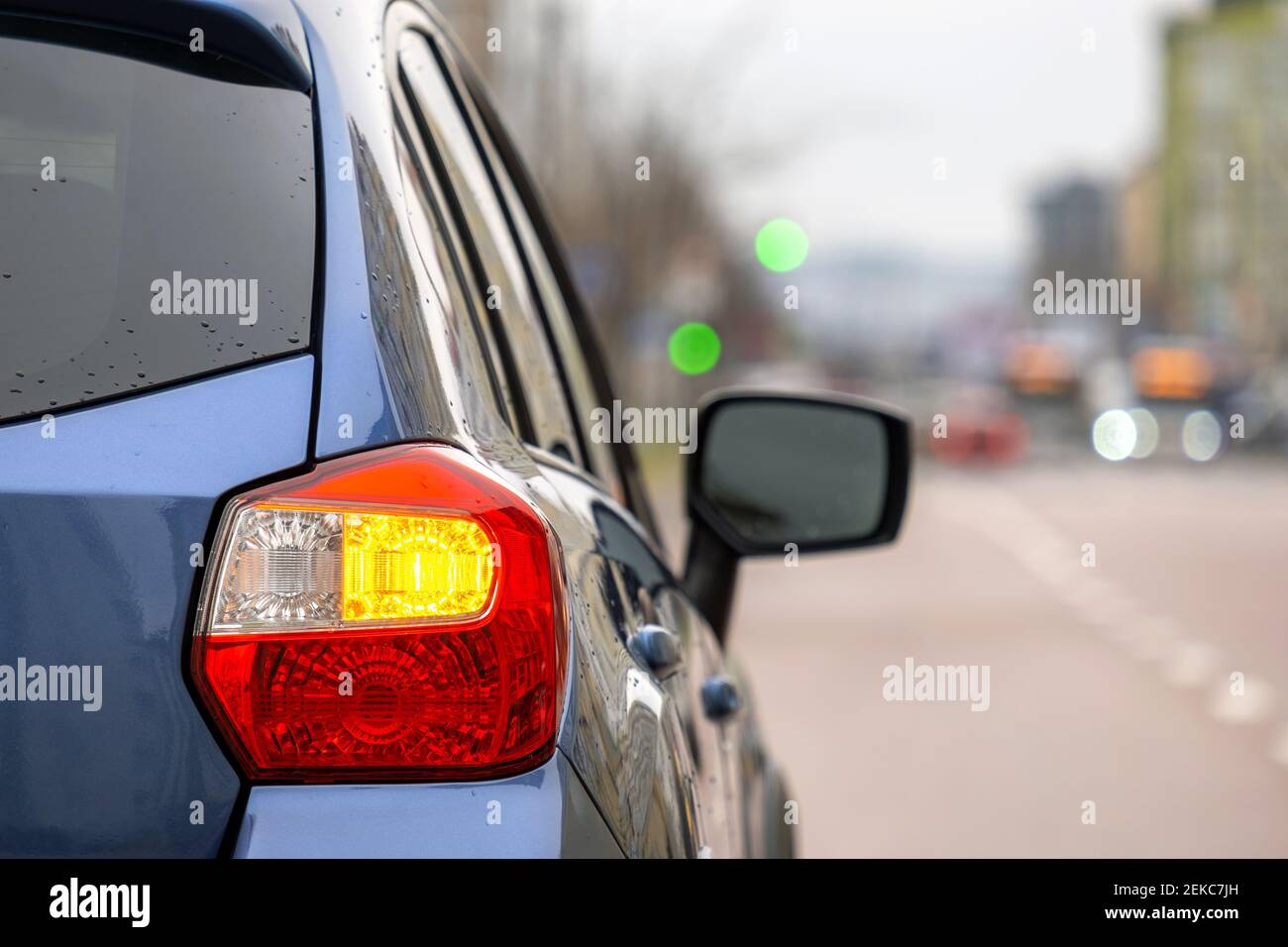 Closeup of rear headlight of new clean car parked on a city street side ...