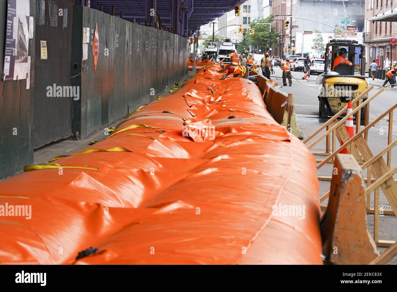 Construction crew erect temporary flood barriers in South Street ...