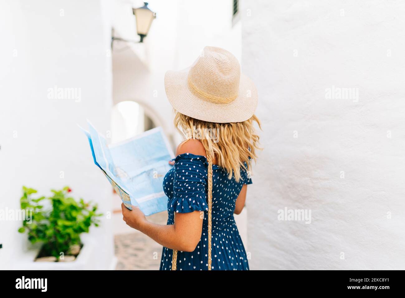 Mature woman wearing h map standing binibeca village hi-res stock ...