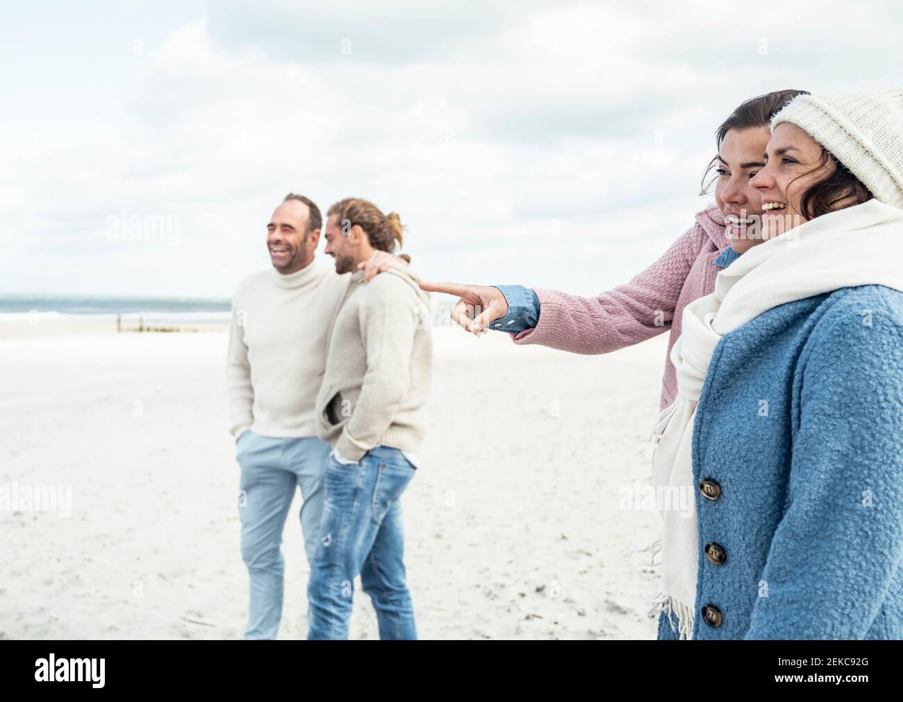 Group of adult friends standing and talking on coastal beach Stock ...