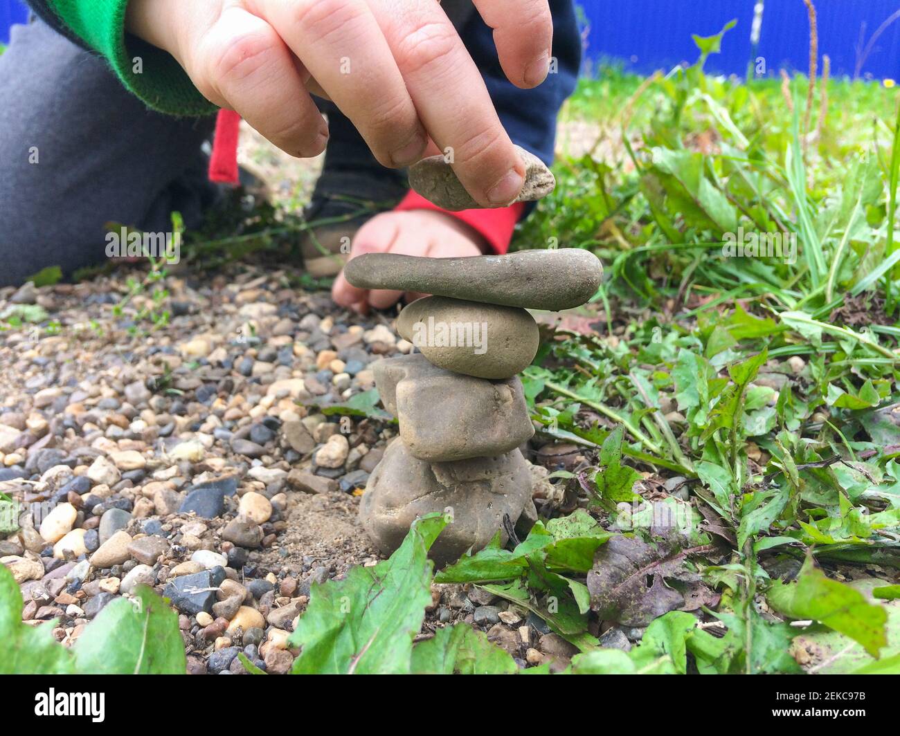 Child stacking rocks hi-res stock photography and images - Alamy
