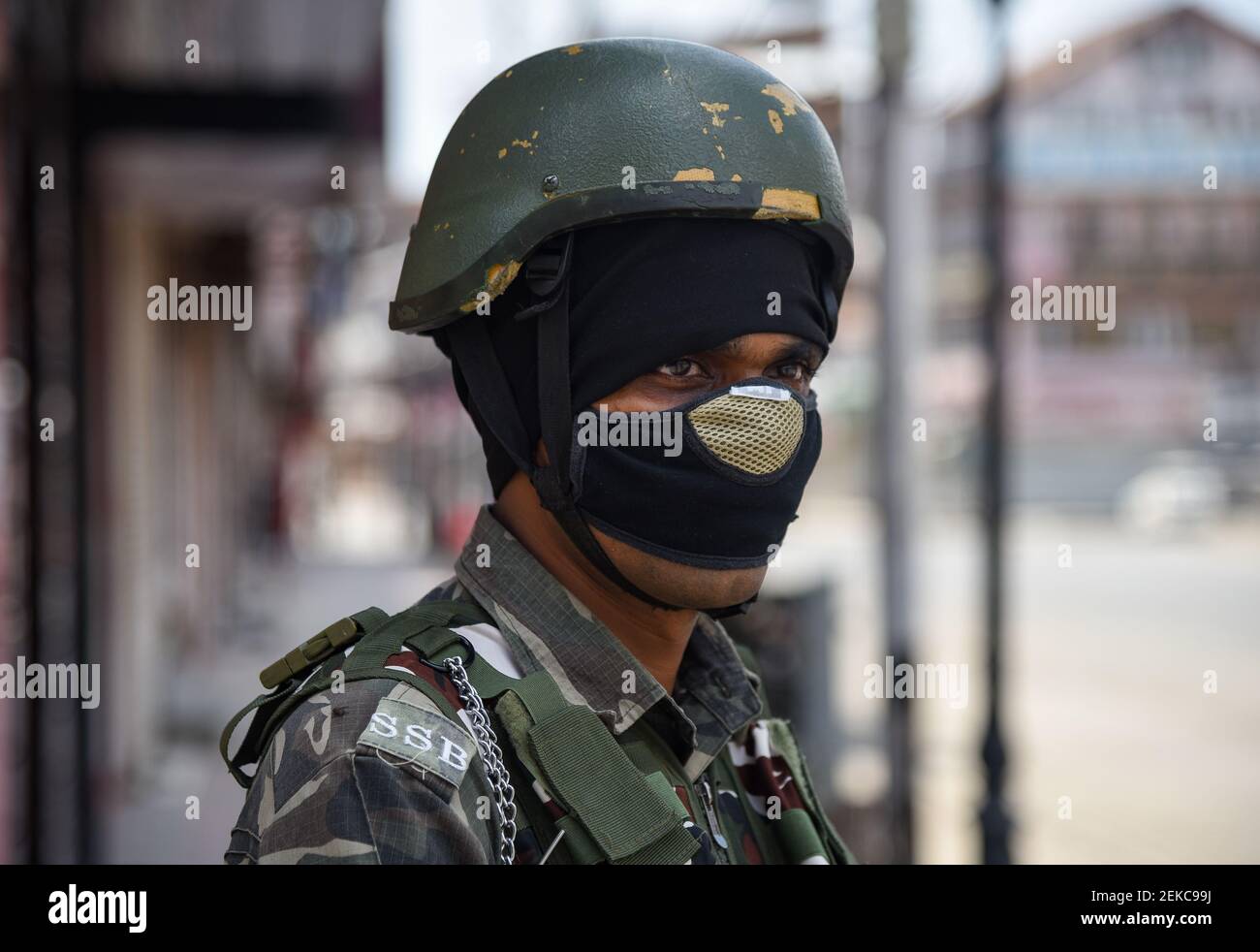 A paramilitary trooper looks on during a curfew in Srinagar ...