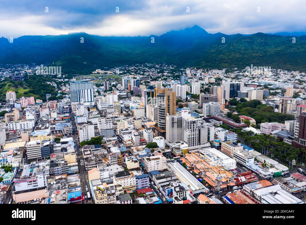 Cityscape against scenic view of mountain range at Port Louis ...