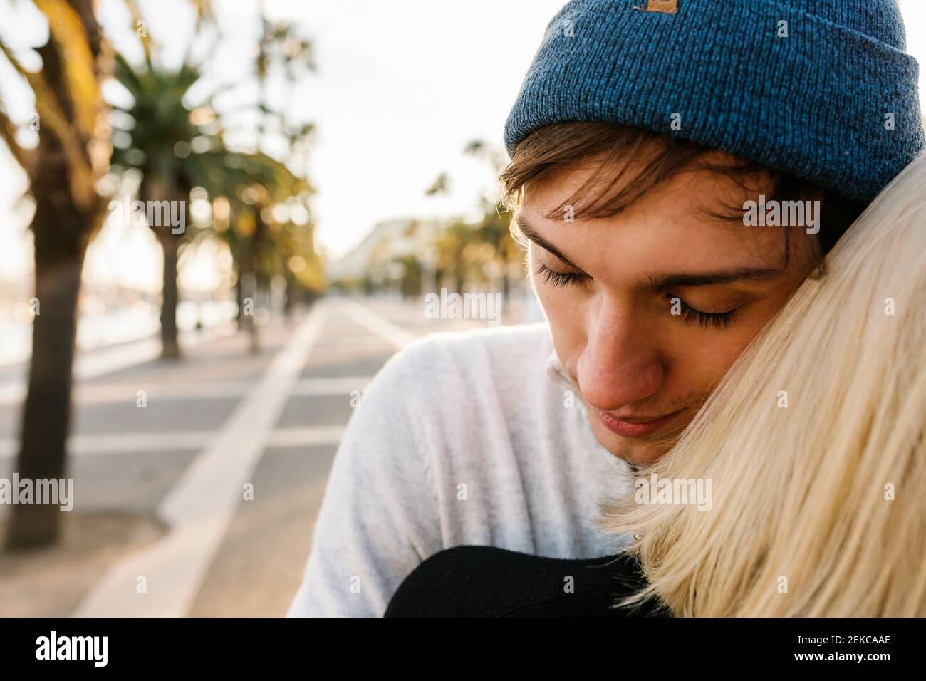 Boyfriend hugging girlfriend at promenade Stock Photo - Alamy