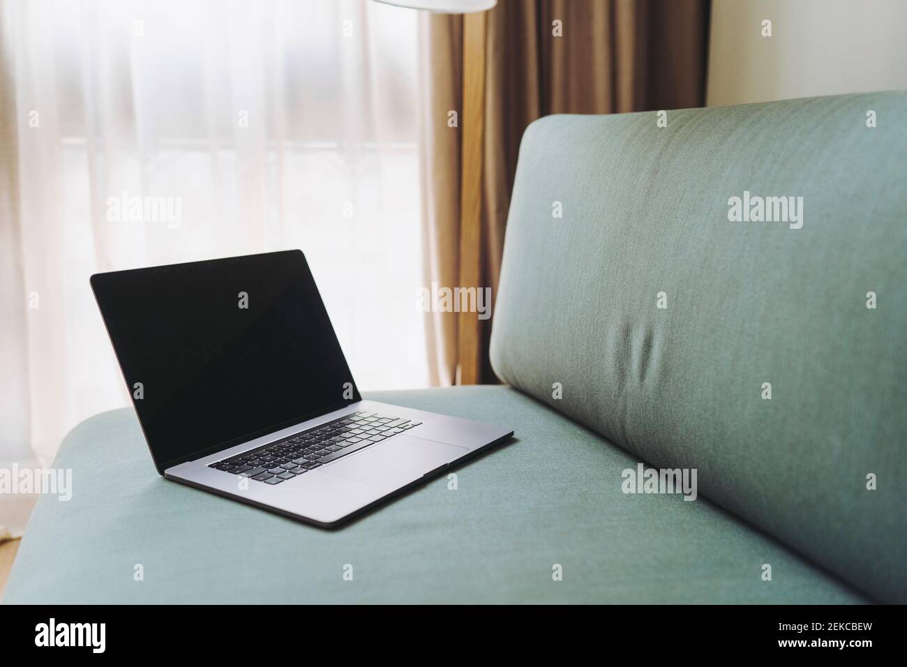Laptop on sofa in hotel room Stock Photo - Alamy