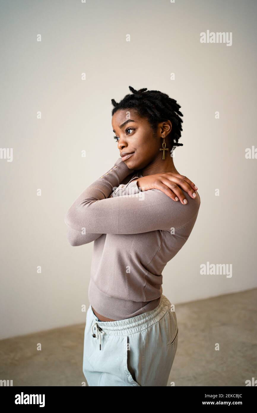 Young woman self hugging at home Stock Photo - Alamy