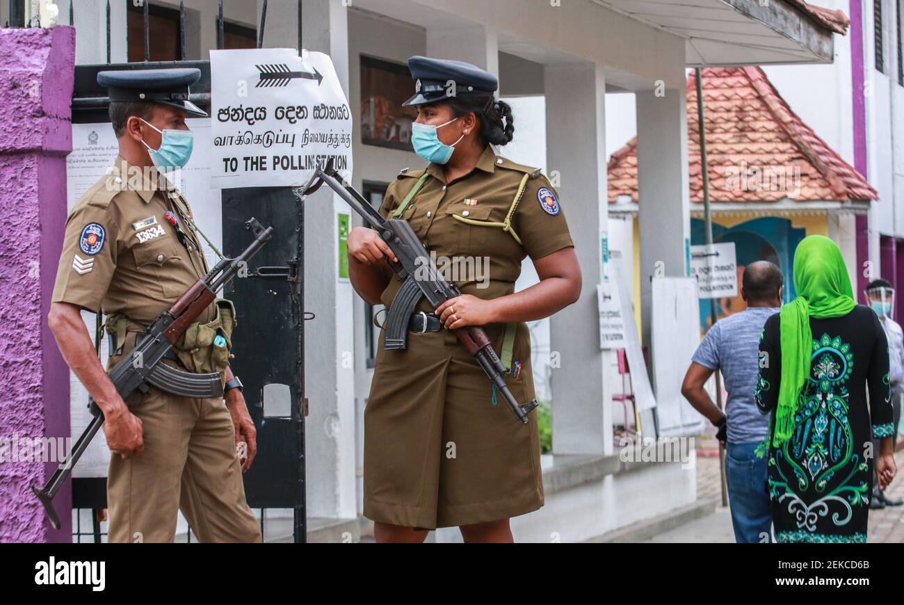 A security personnel stands guard outside a polling station during the ...
