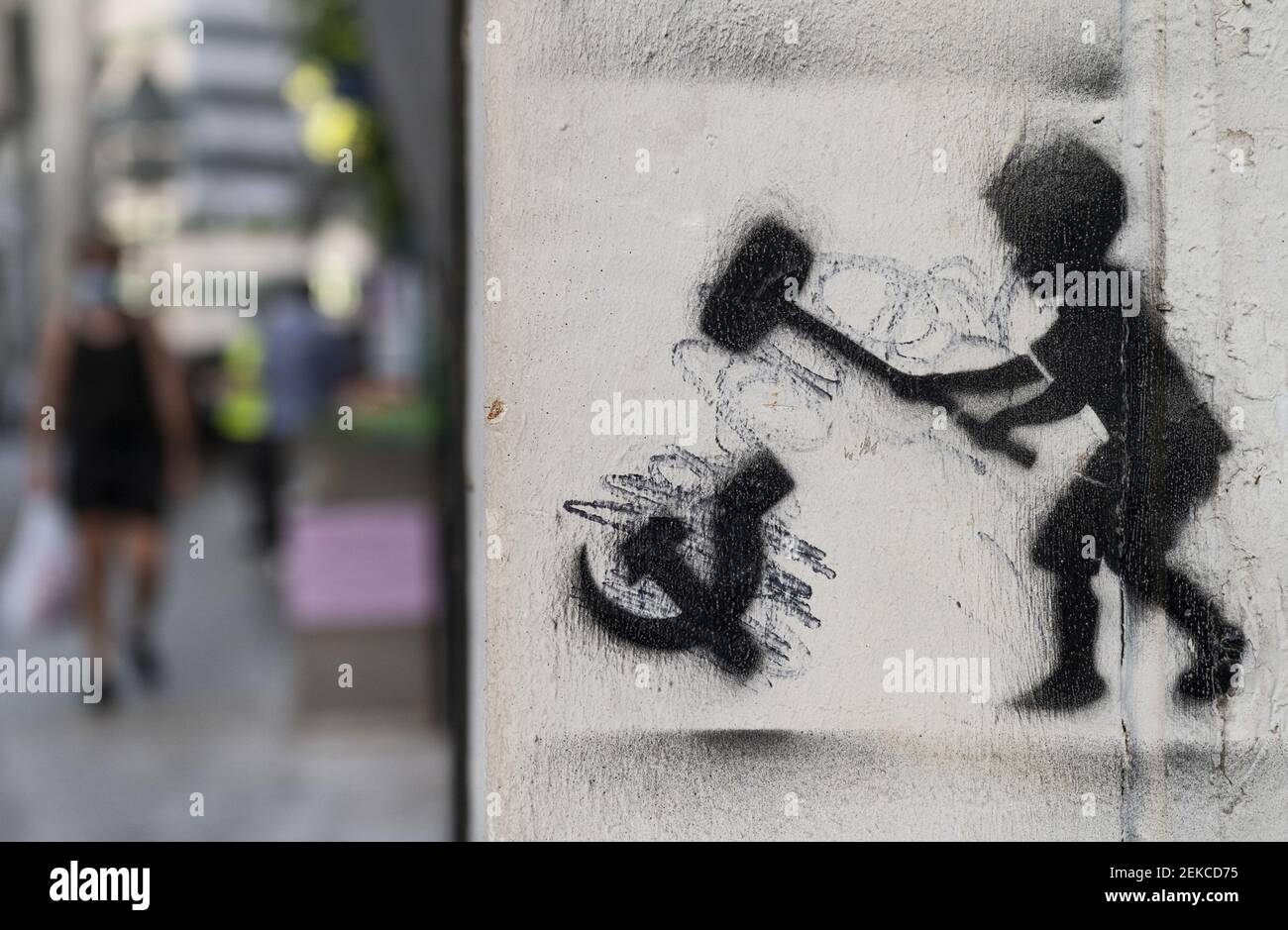 A graffiti is seen depicting a child hammering the communism symbol in ...