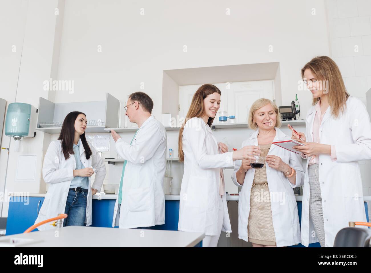 Researchers discussing in a lab Stock Photo - Alamy