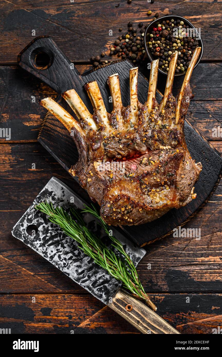 Grilled rack ribs of lamb meat chops. Dark wooden background. Top view ...