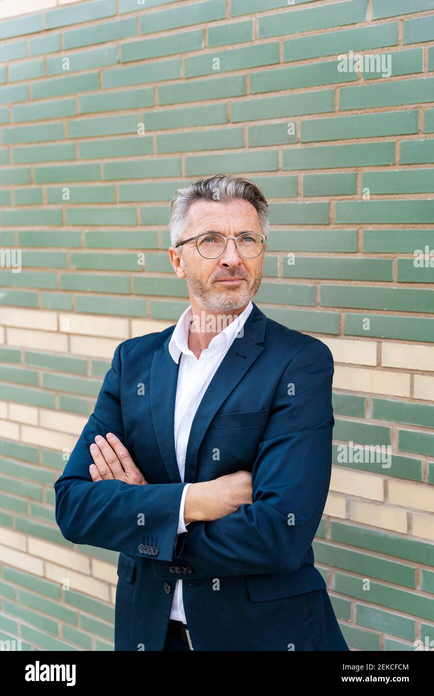 Confident businessman standing wall hi-res stock photography and images ...