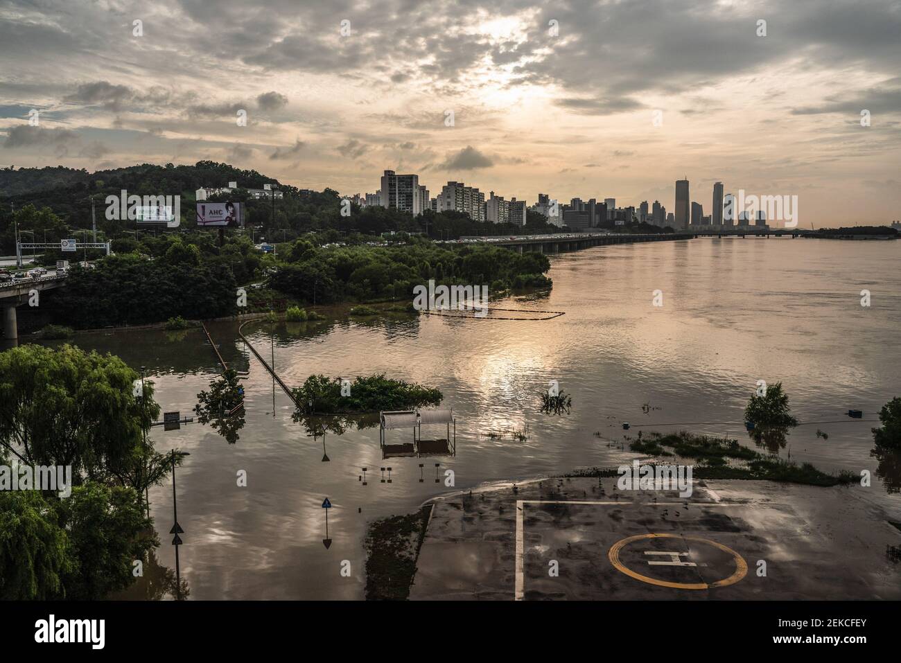 View of a flooded street and signs of Han river park after heavy rains ...