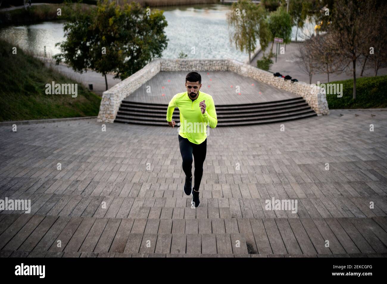 Male athlete running on steps at park Stock Photo - Alamy