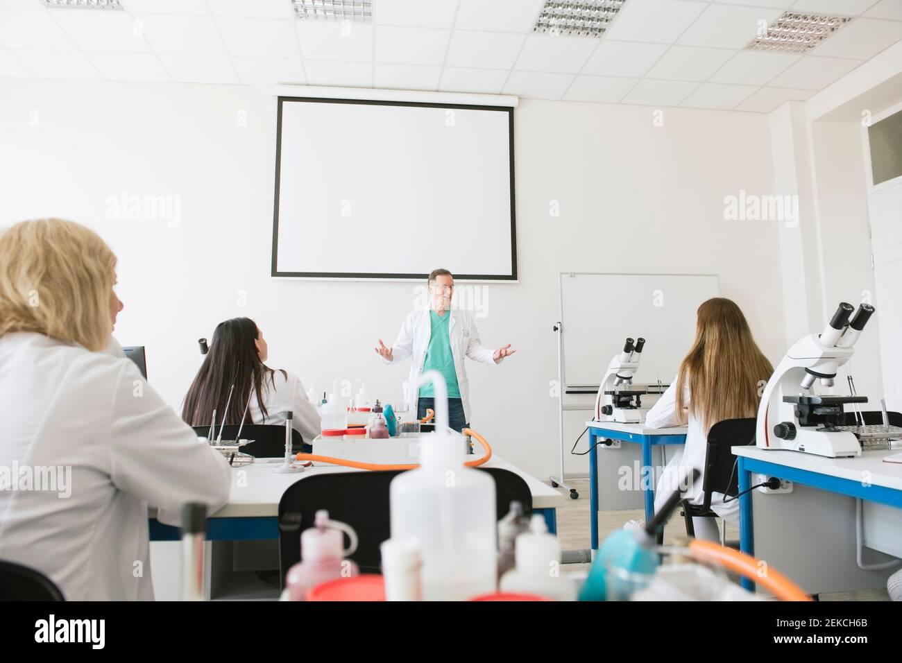 Students and teacher working in science class Stock Photo - Alamy