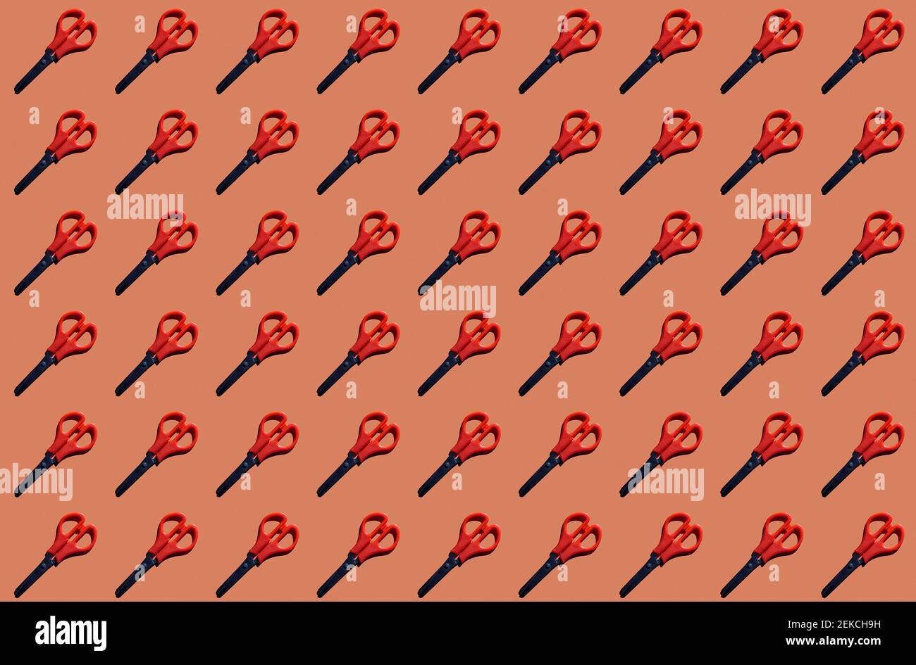 Pattern of rows of scissors against red background Stock Photo - Alamy