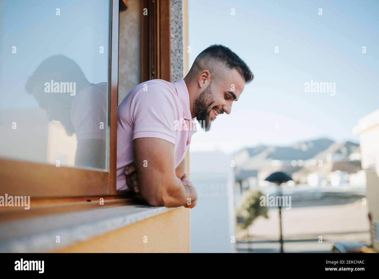 Man leaning out window hi-res stock photography and images - Alamy