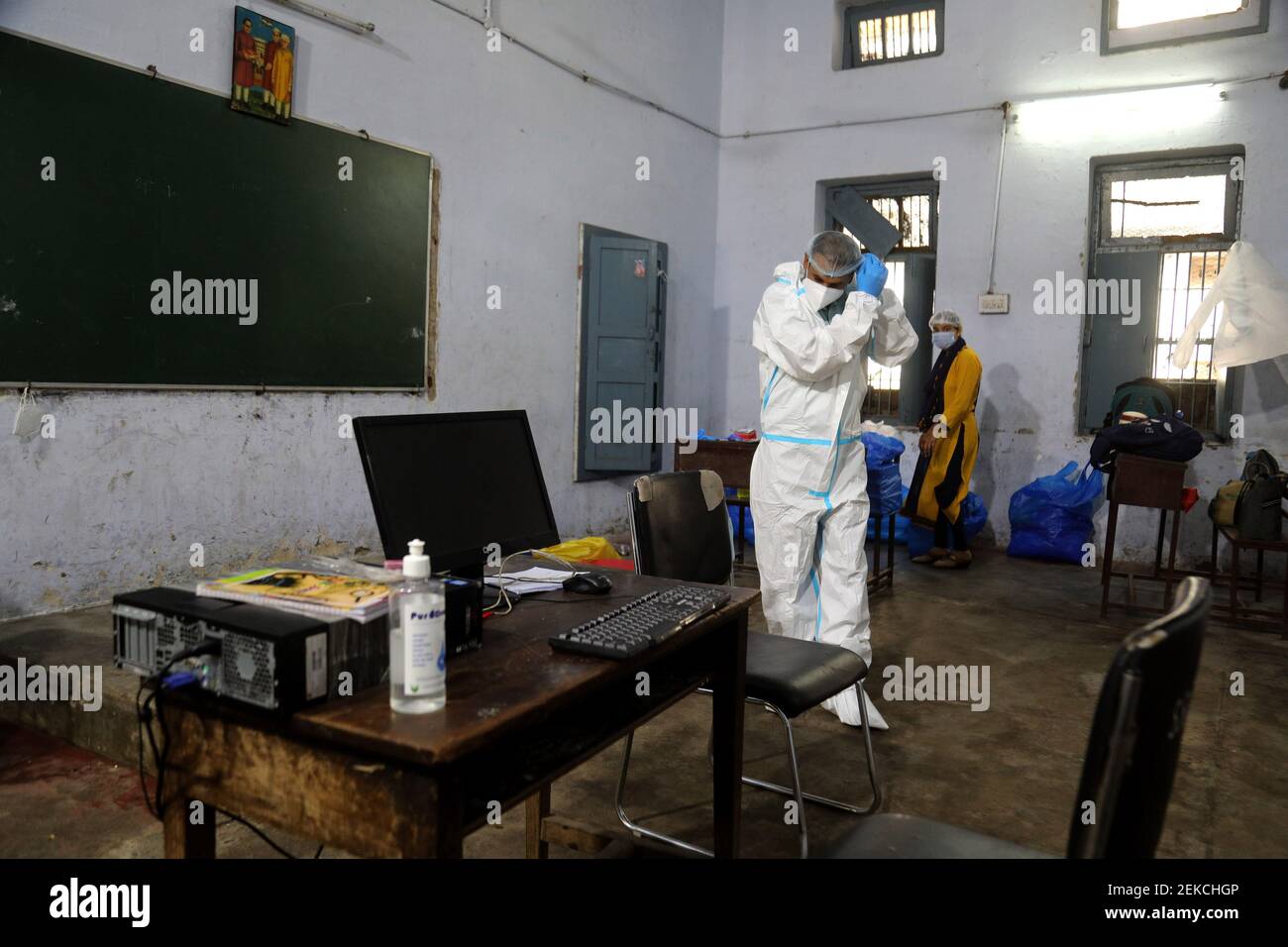 A medic wearing personal protective equipment (PPE) getting ready for ...