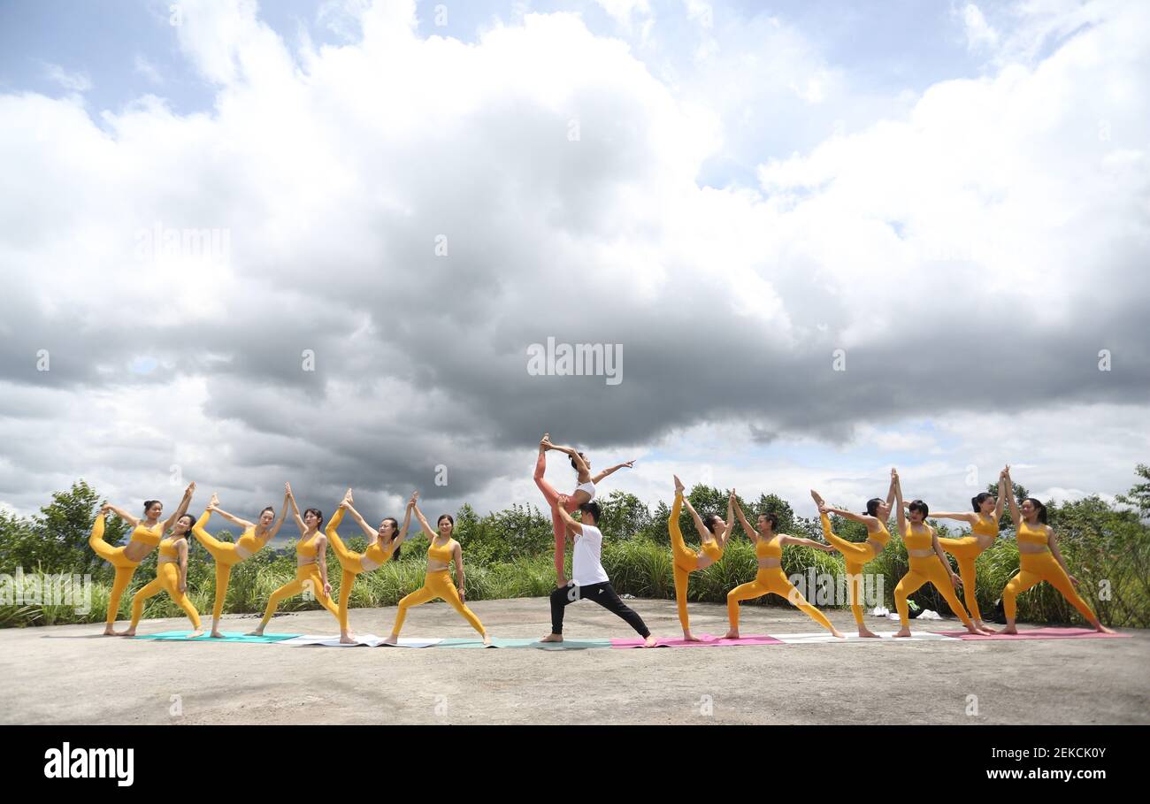 GUIYANG, CHINA - AUGUST 7, 2020 - Yoga devotees practice yoga in a ...