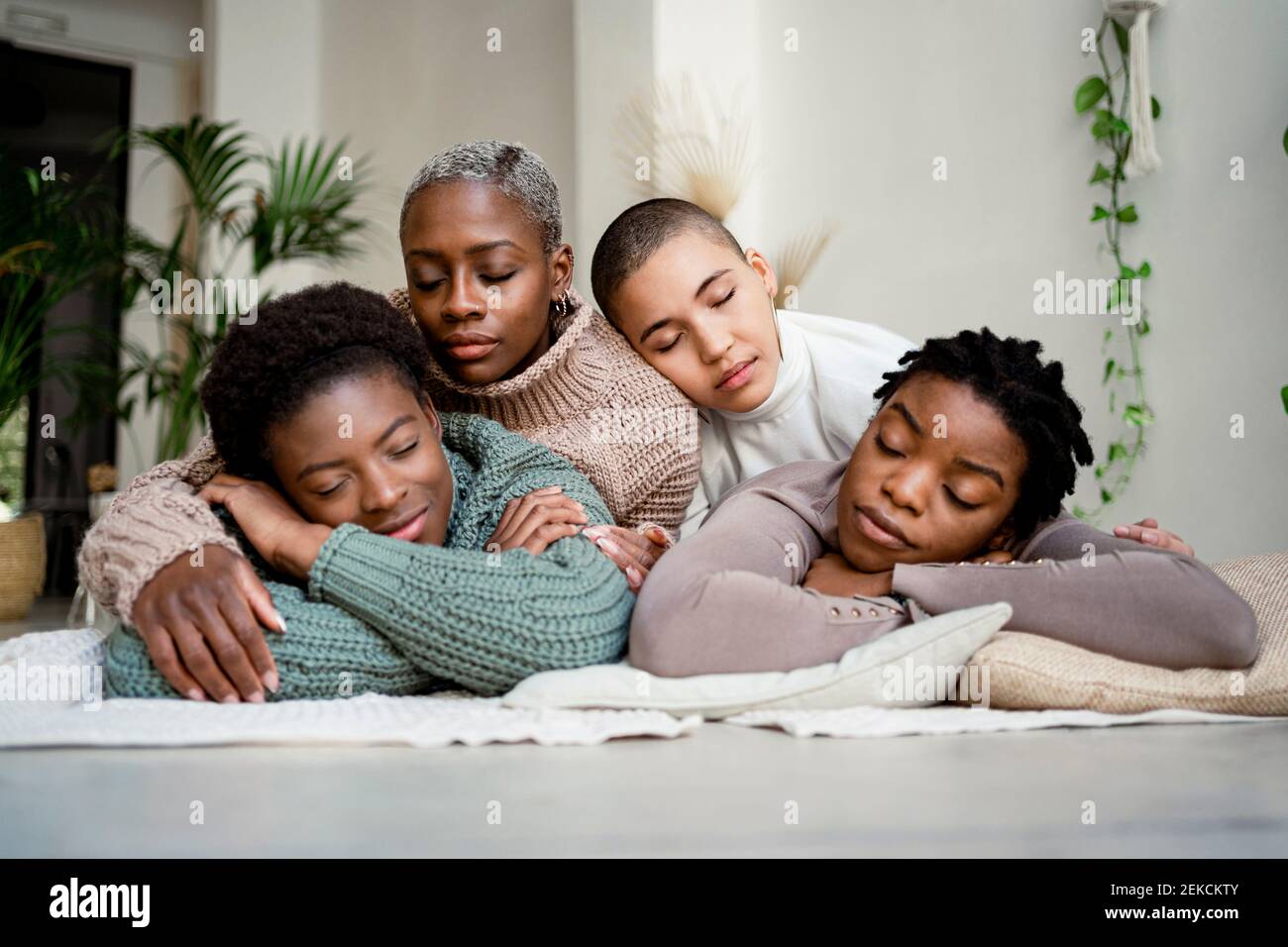 Female friends relaxing in living room at home Stock Photo - Alamy