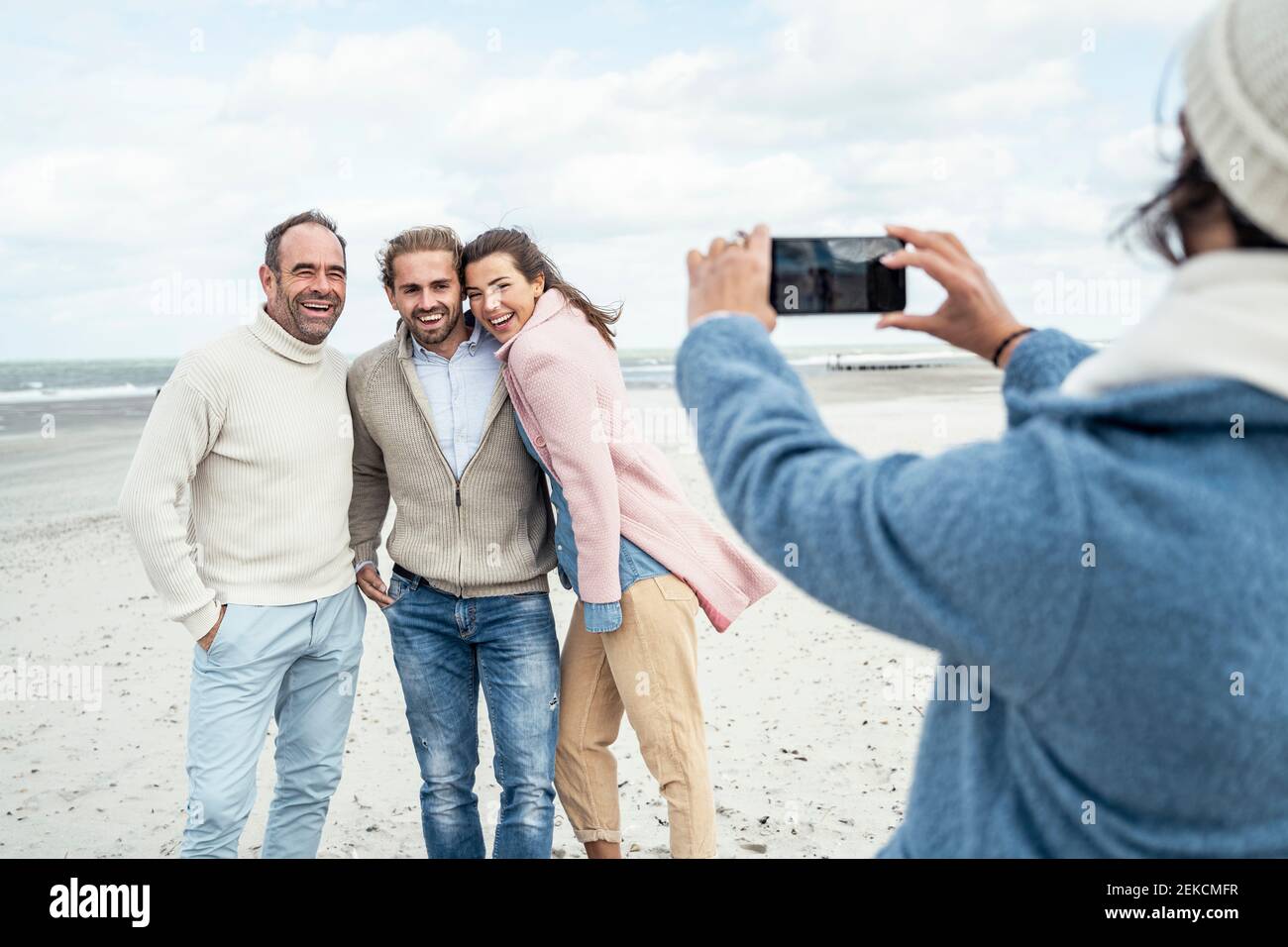 Group of friends taking smart phone photos at beach Stock Photo - Alamy