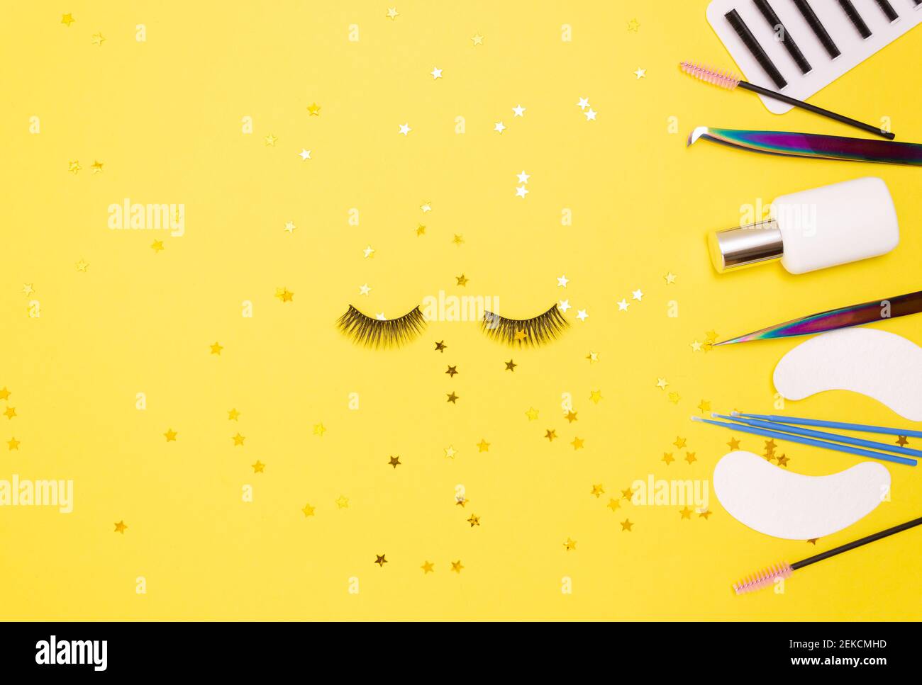 Eyelash extension tools and artificial eyelashes on a yellow background ...