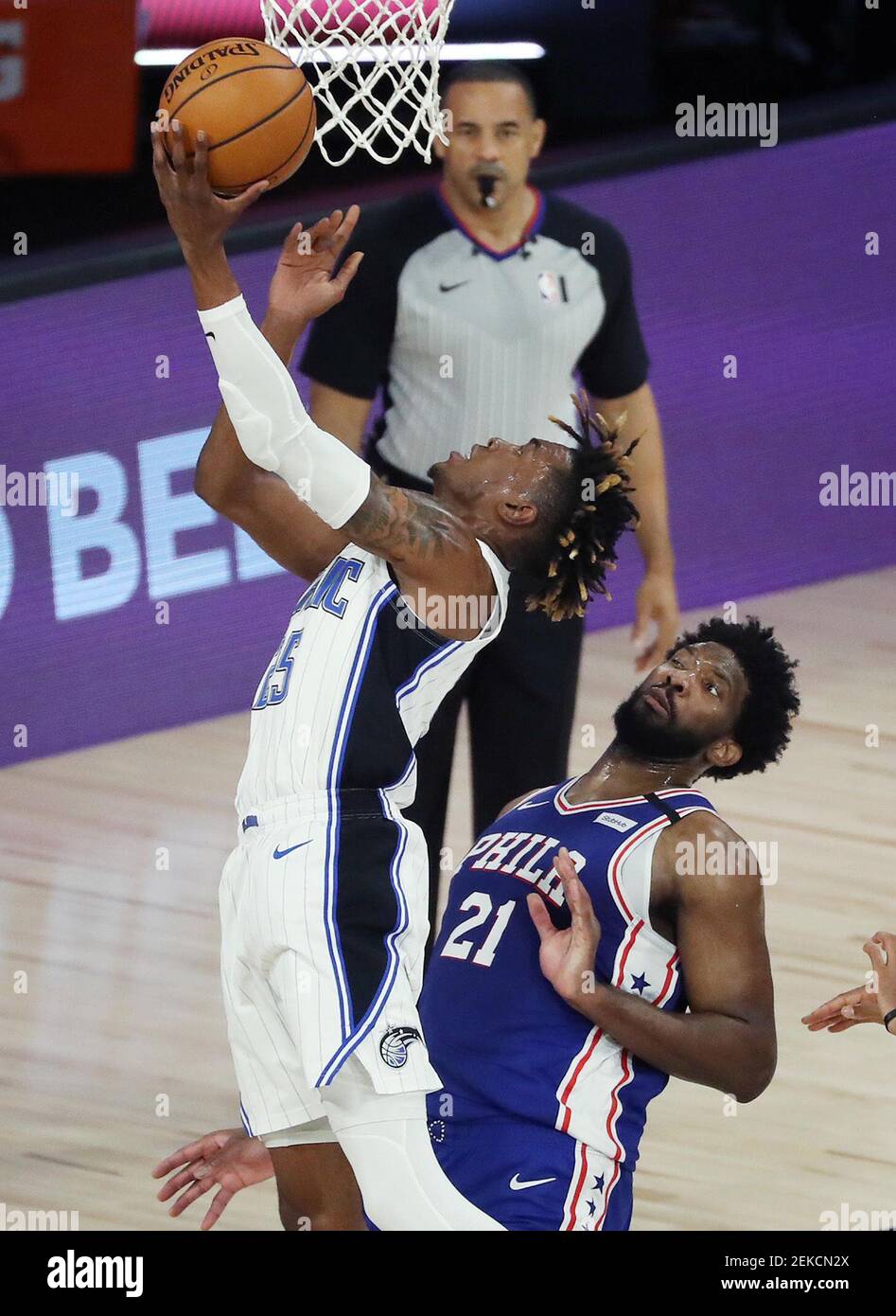 The Orlando Magic's Wes Iwundu (25) scores over the Philadelphia 76ers ...