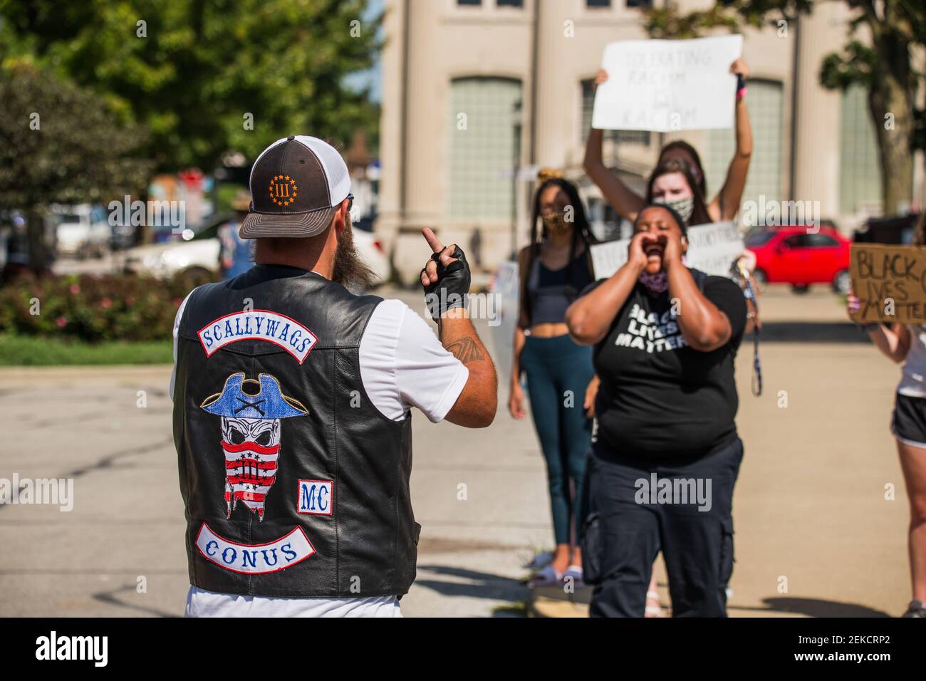 A member of the Scallywags III-percenter motorcycle club flips off ...