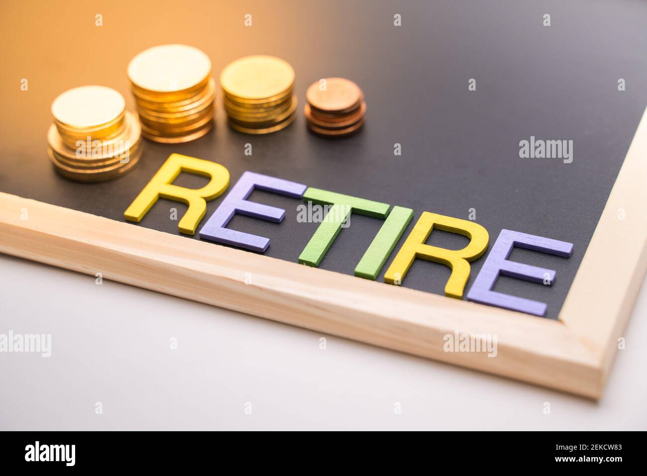 Retire word on blackboard Stock Photo - Alamy