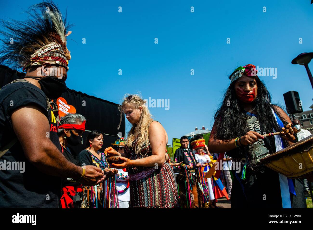 A group of people taking part in an indigenous ceremony during the ...