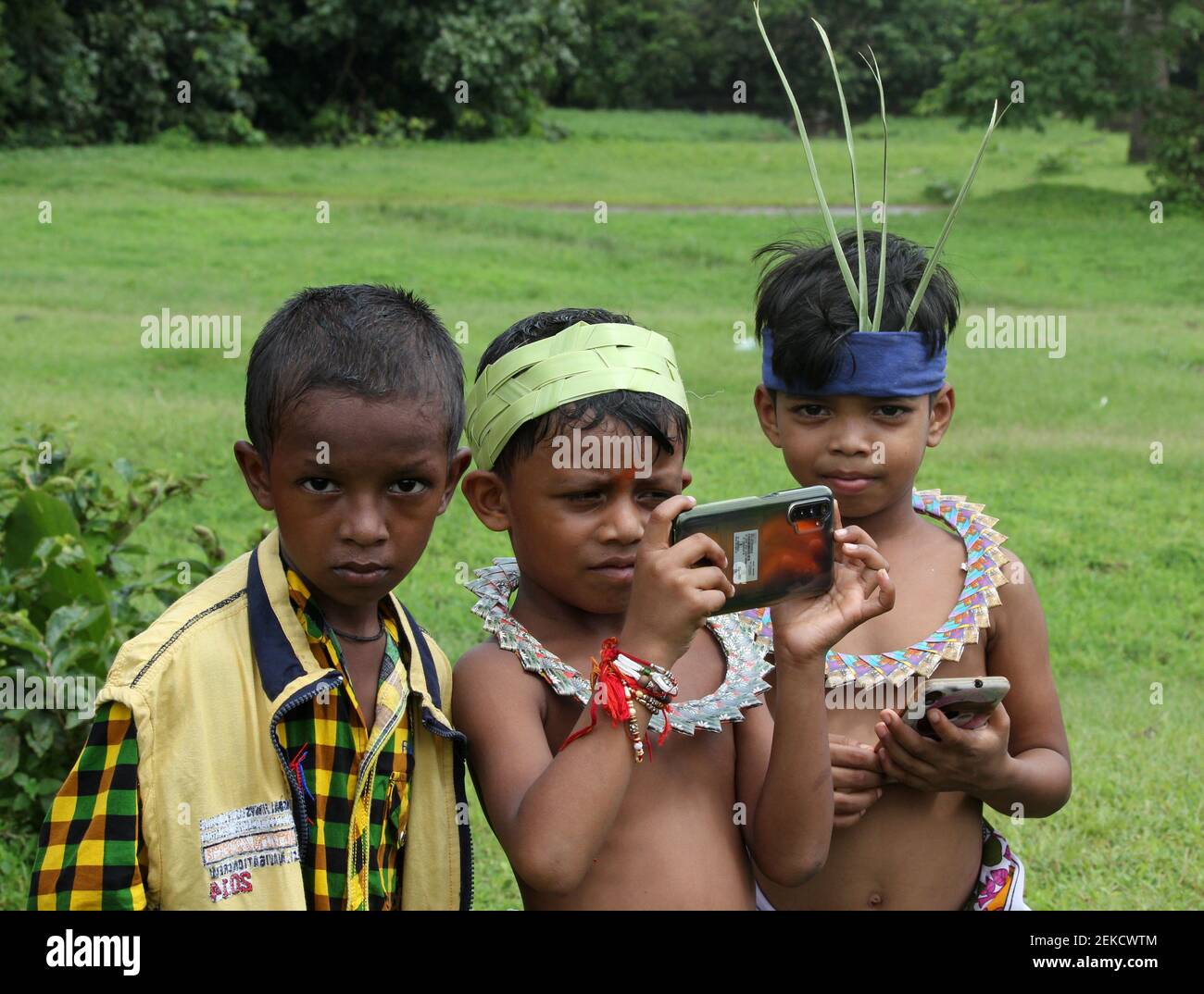 An indigenous boy checking a phone with his friends during the ...