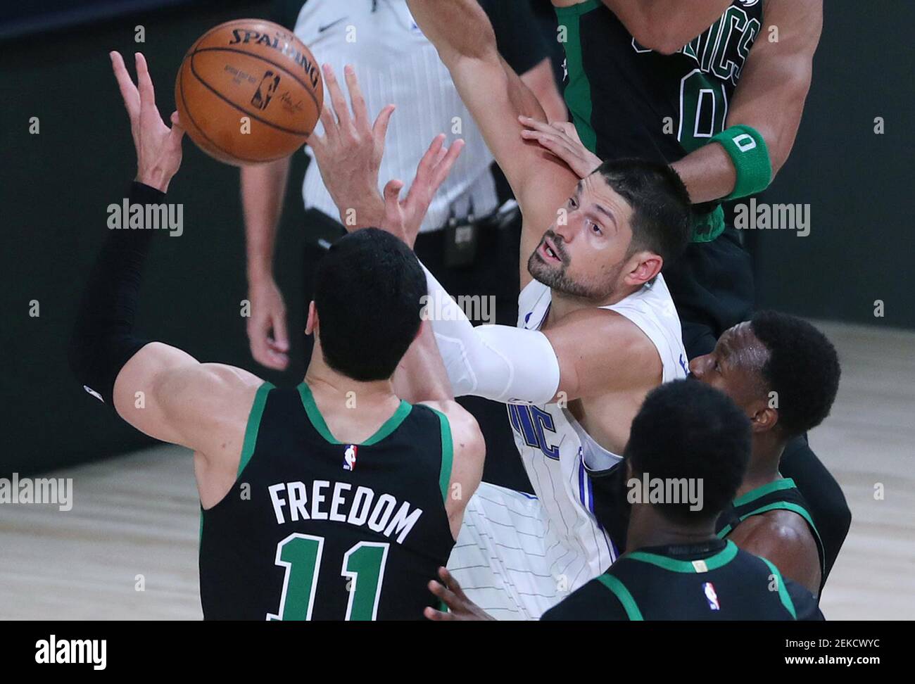 Boston Celtics center Enes Kanter (11) stops Orlando Magic center ...