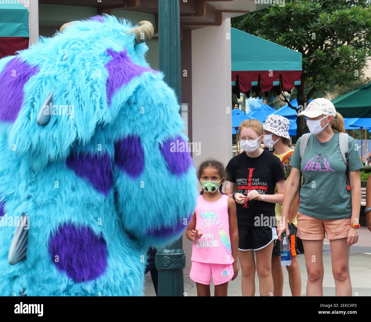 Guests wave to Sulley of Monsters, Inc. during a pop-up appearance of ...