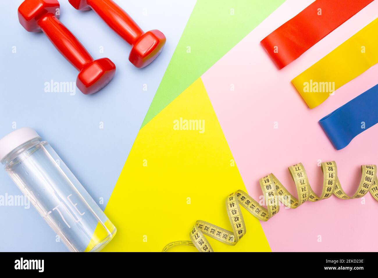 Red weights, a centimeter ribbon and elastic bands for sports on a ...