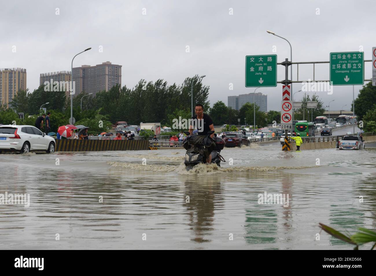 People travel through the city logging caused by heavy rainfall in ...