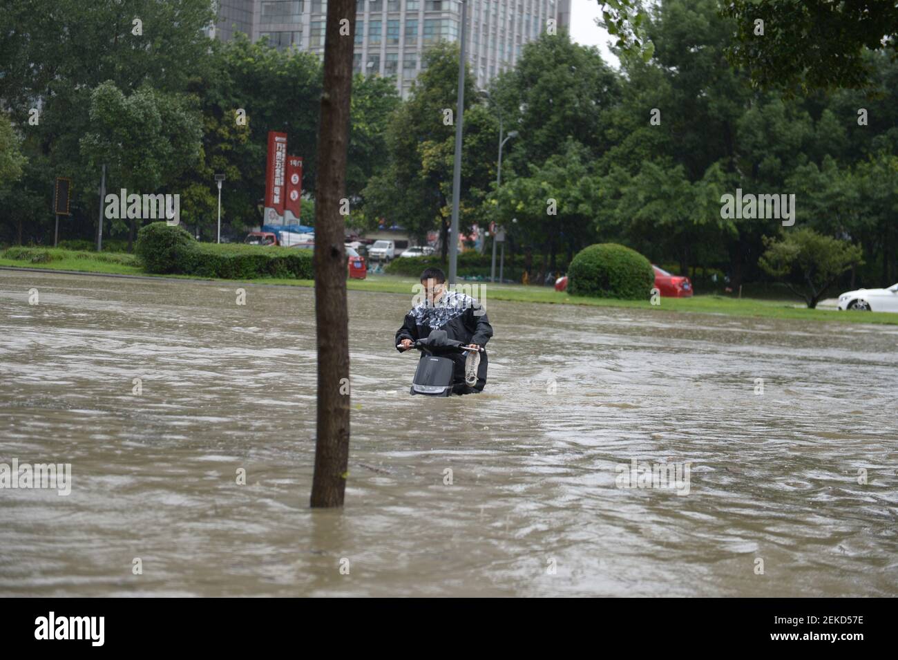 People travel through the city logging caused by heavy rainfall in ...