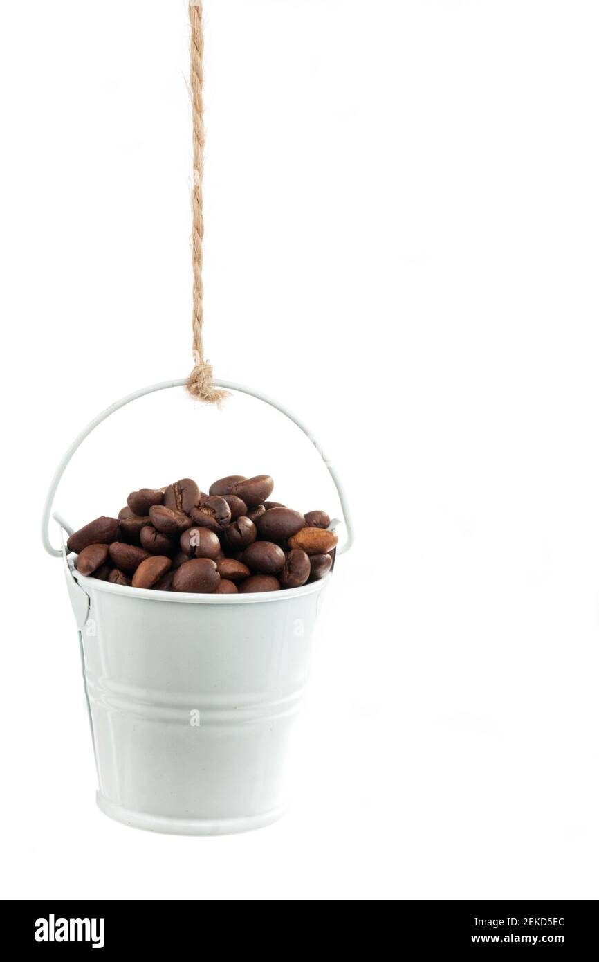 A full bucket of coffee beans hanging from a rope. White background ...