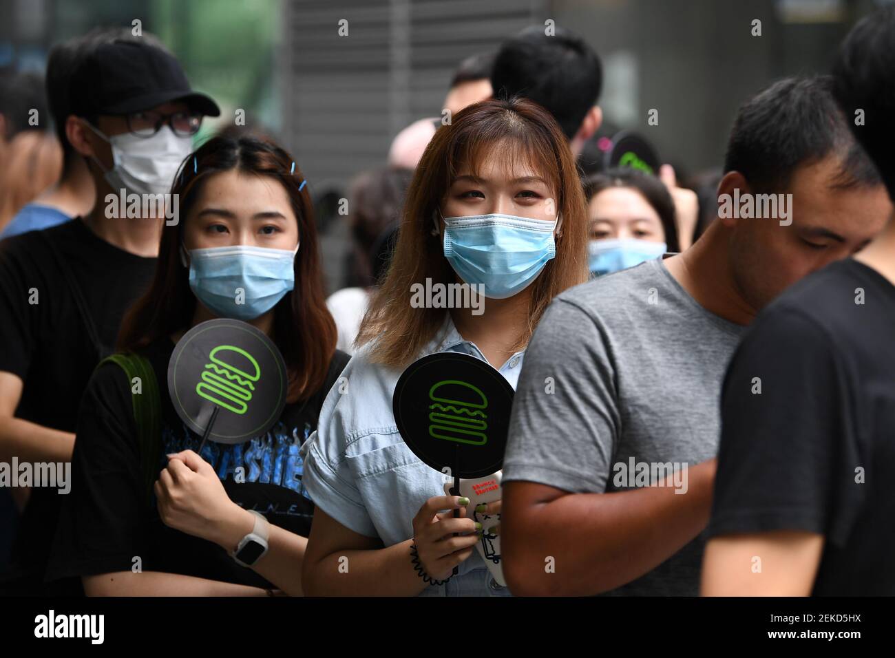 People line up to get burgers at the Shake Shack store at Sanlitun in ...