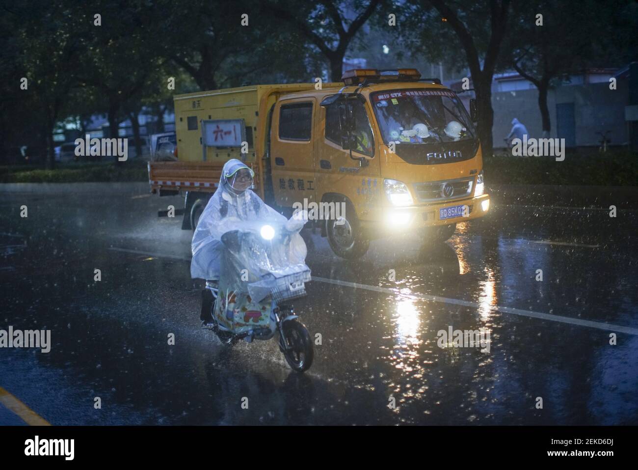 Motor, pedestrians and vehicles trek in the downpour, which might be ...
