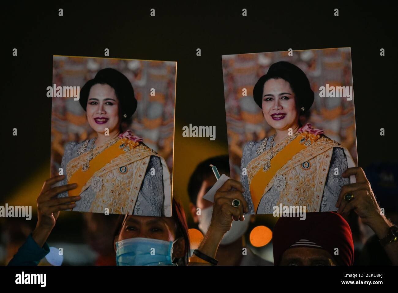 Thai well-wishers hold pictures of Thai Queen Sirikit as they attend ...