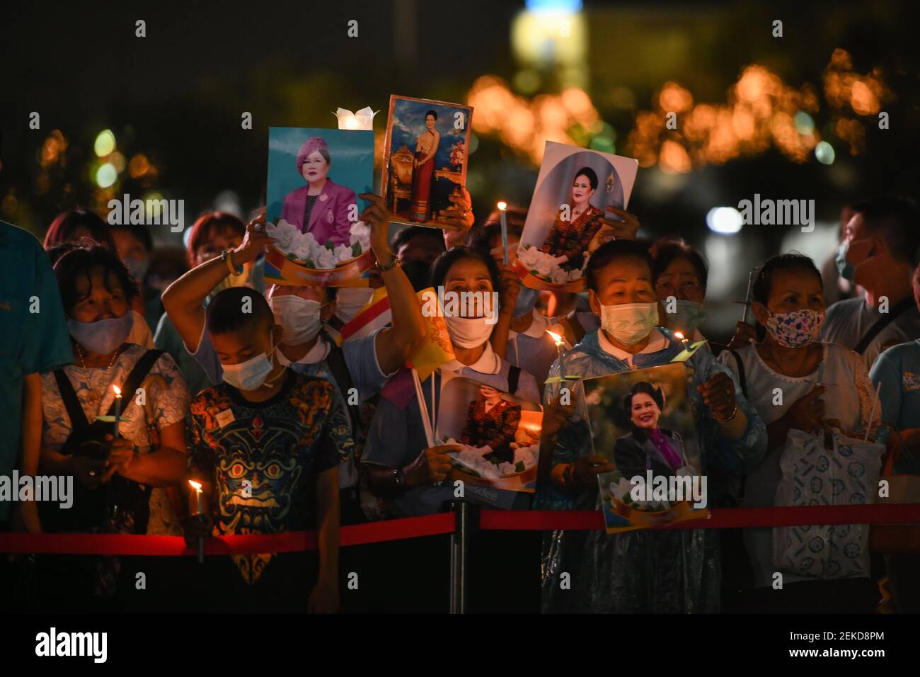 Thai well-wishers hold pictures of Thai Queen Sirikit as they attend ...