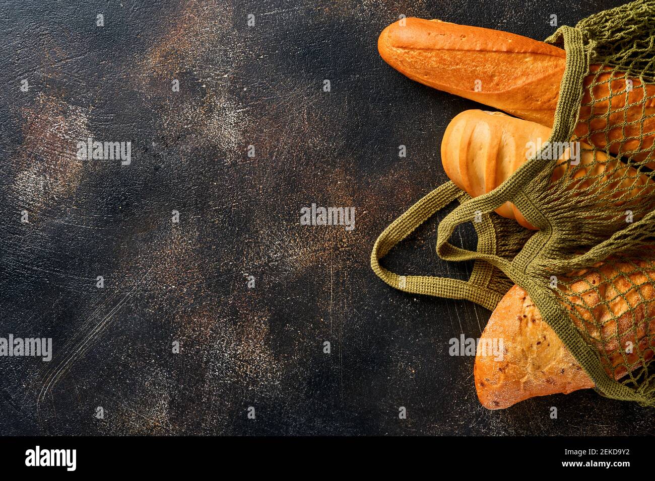 Various crispy breads and buns in mesh bags or shopping bag, wheat ...