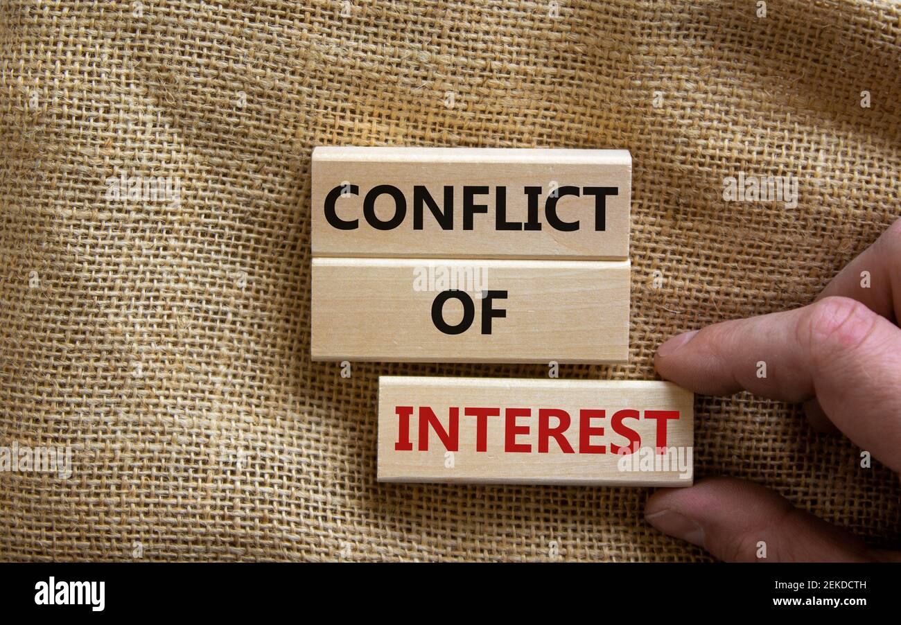 Conflict of interest symbol. Wooden blocks with words 'conflict of ...