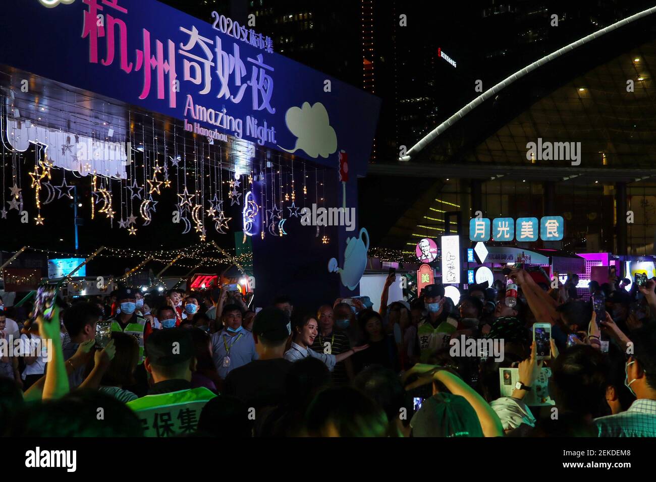 People walk around and shop at the "2020 Amazing Night in Hangzhou", a ...